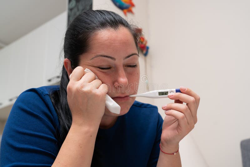 Female Model Checking Body Temperature Using Thermometer Stock Image ...
