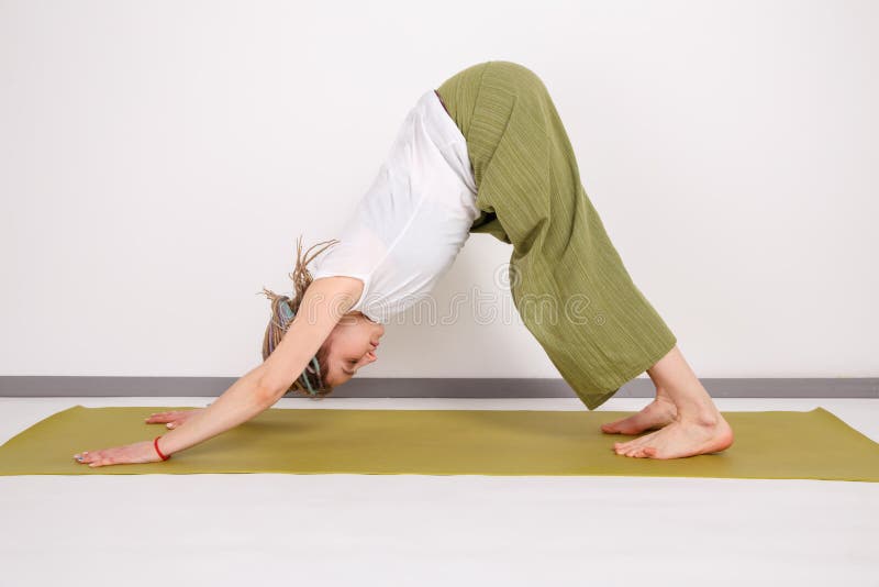 Female Model in Yoga Pose in the Studio. Young Woman Doing Exercises ...