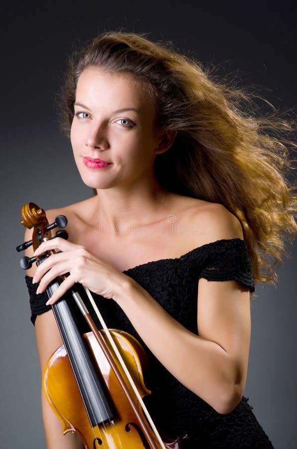 The Female Musical Player Against the Dark Stock Photo - Image of ...