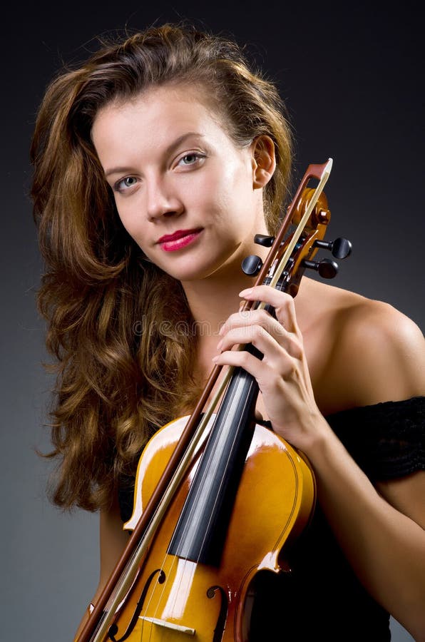 Female Musical Player Against Dark Background Stock Photo - Image of ...