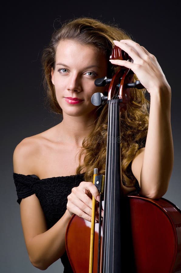 Female Musical Player Against Dark Background Stock Image - Image of ...