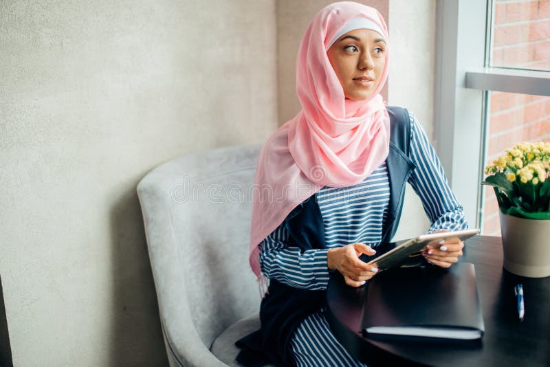 Female Muslim College Student Using Tablet Computer in Cafe Stock Photo ...