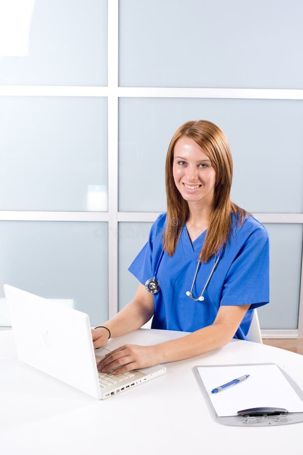Female nurse at a desk stock photo. Image of holding - 10146038
