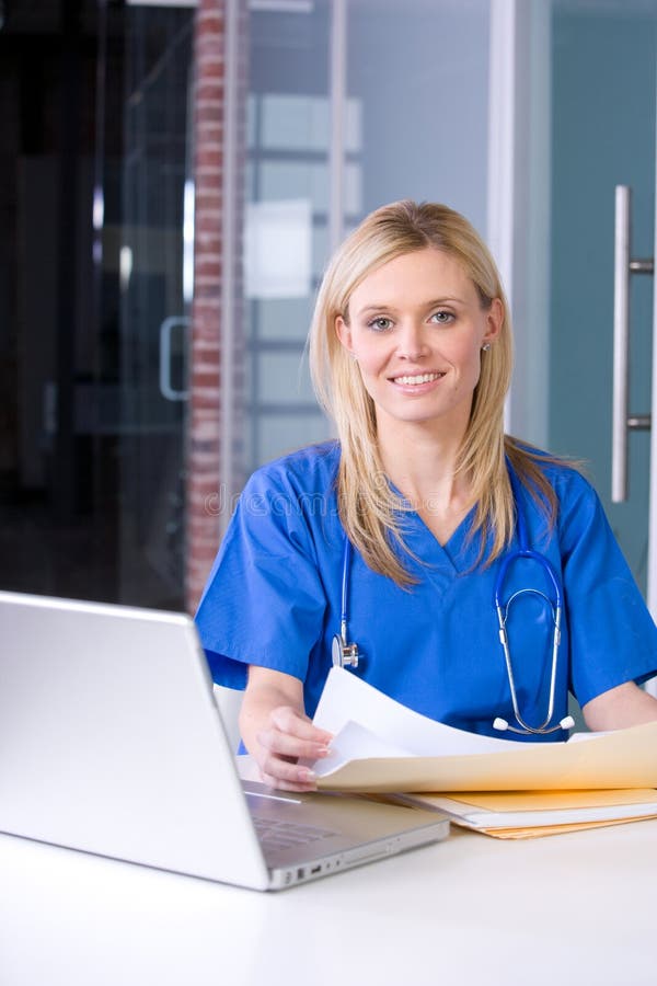 Female Nurse at a Desk Working Stock Photo - Image of beautiful, happy ...