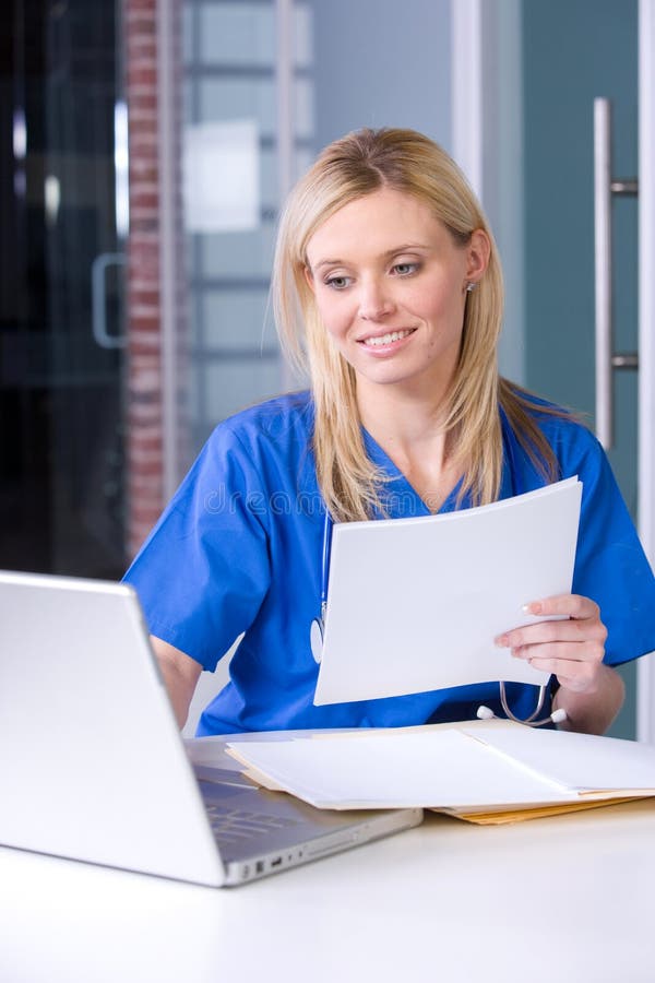 Female Nurse at a Desk Working Stock Photo - Image of hospital, pretty ...
