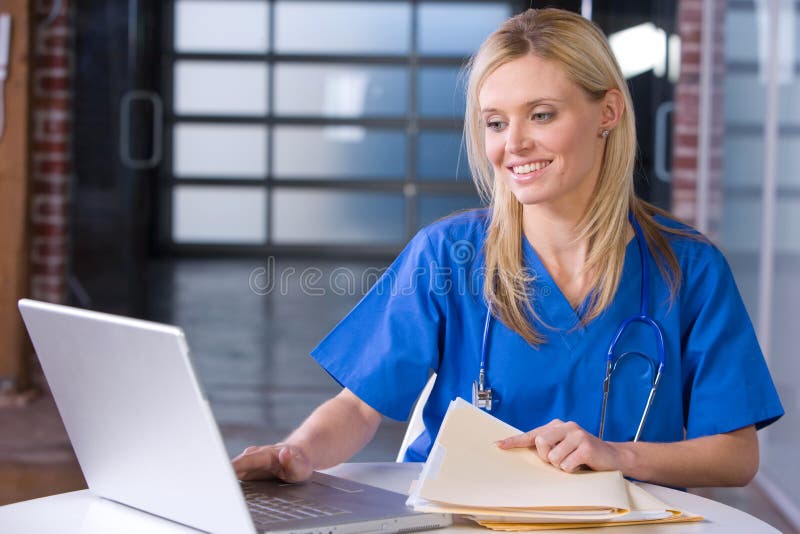 Female Nurse at a Desk Working Stock Photo - Image of beautiful, happy ...