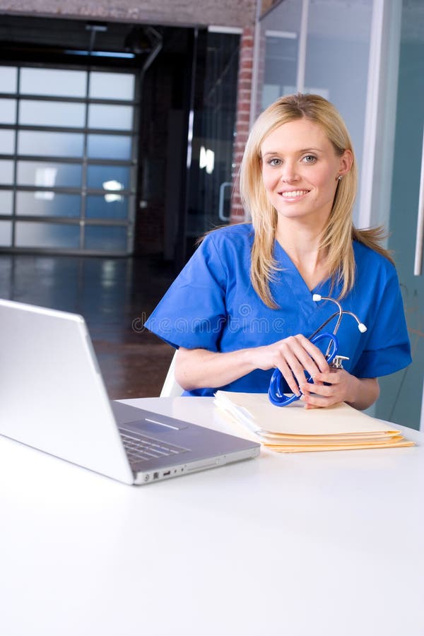 Female Nurse at a Desk Working Stock Photo - Image of beautiful ...