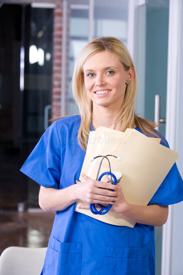 Female Nurse at a Desk Working Stock Photo - Image of document, blue ...