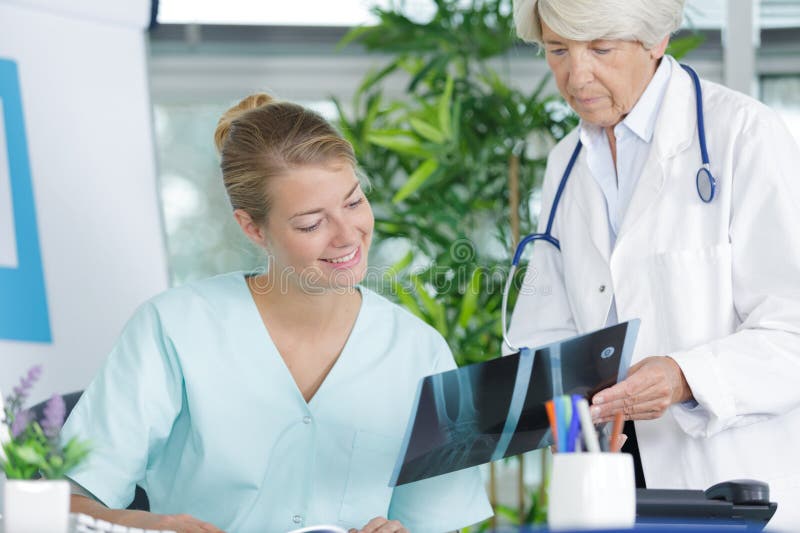 Female Nurse and Doctor Look Attentively at X Ray Stock Photo - Image ...