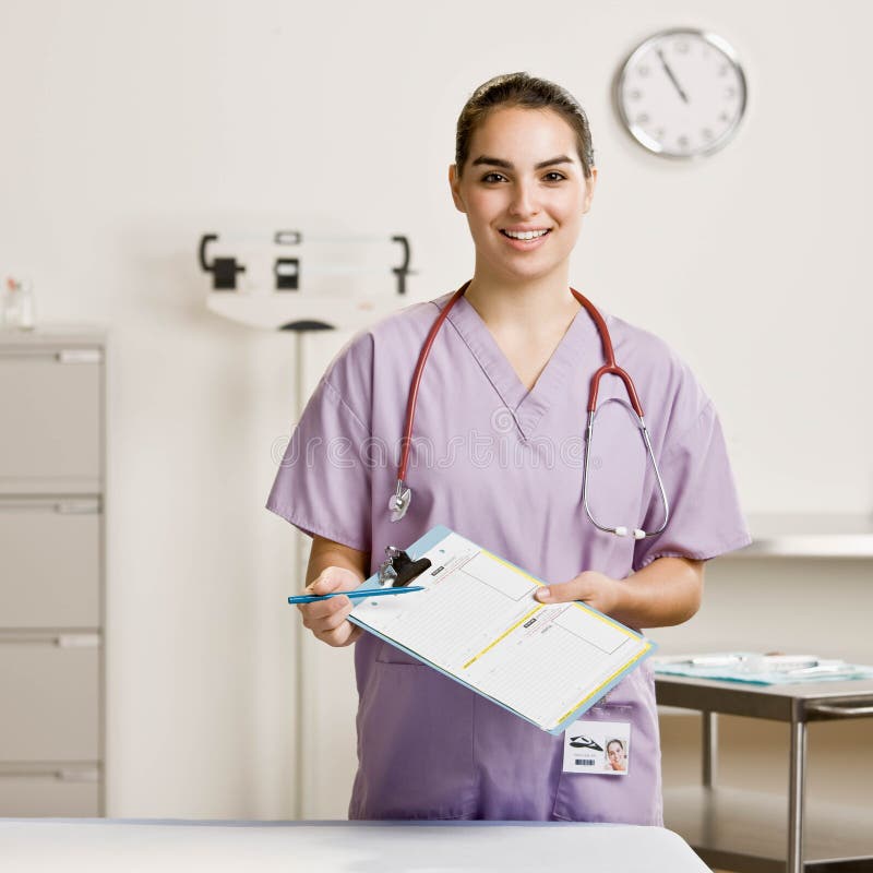 Female Nurse Holding Out Forms Stock Photo - Image of portrait, smile ...