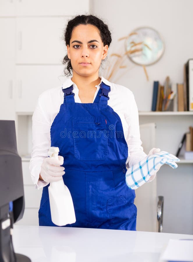Female Office Cleaner is Cleaning Dust from the Desk in Office Stock ...