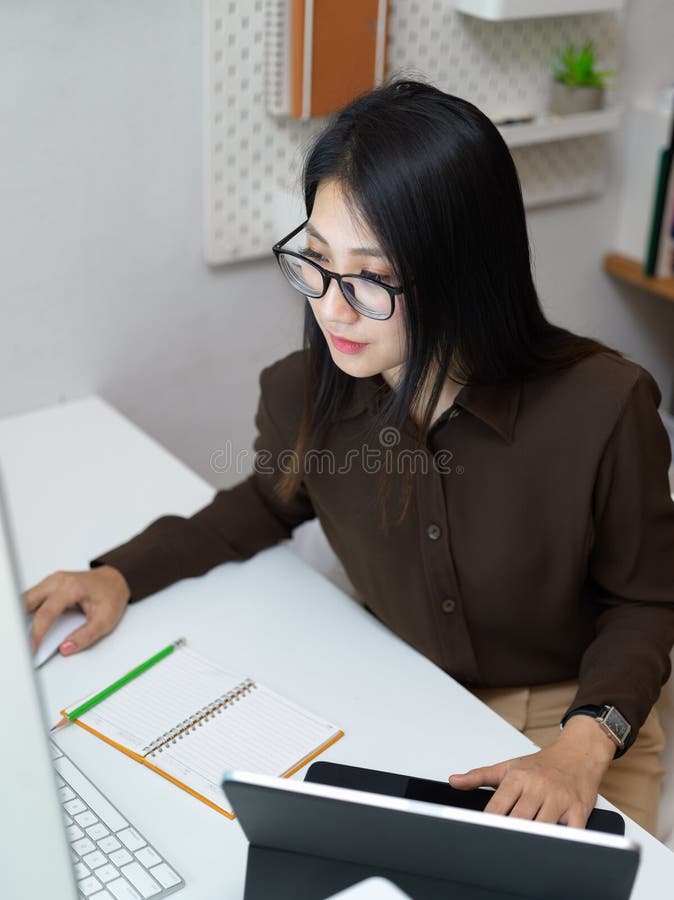Female Office Worker Concentrating on Her Work with Computer and Office ...