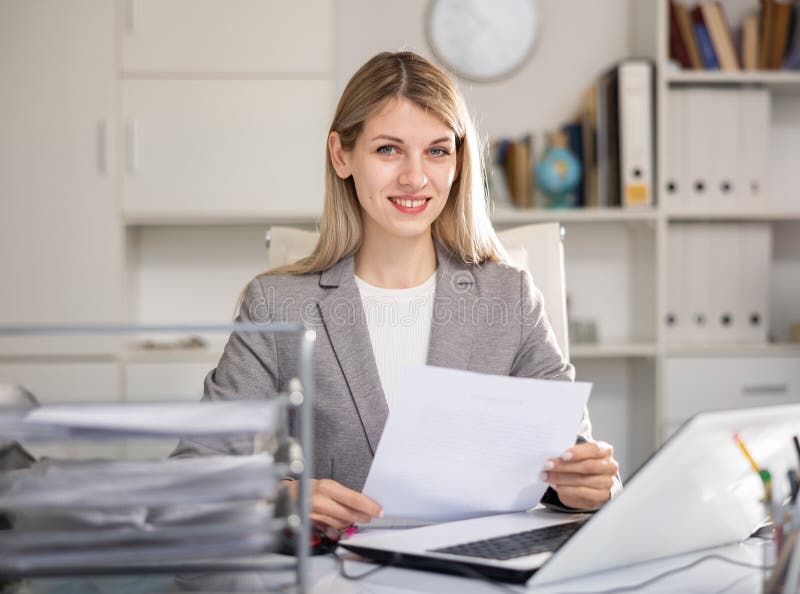 Female Office Worker Doing Paperwork Stock Image - Image of laptop ...