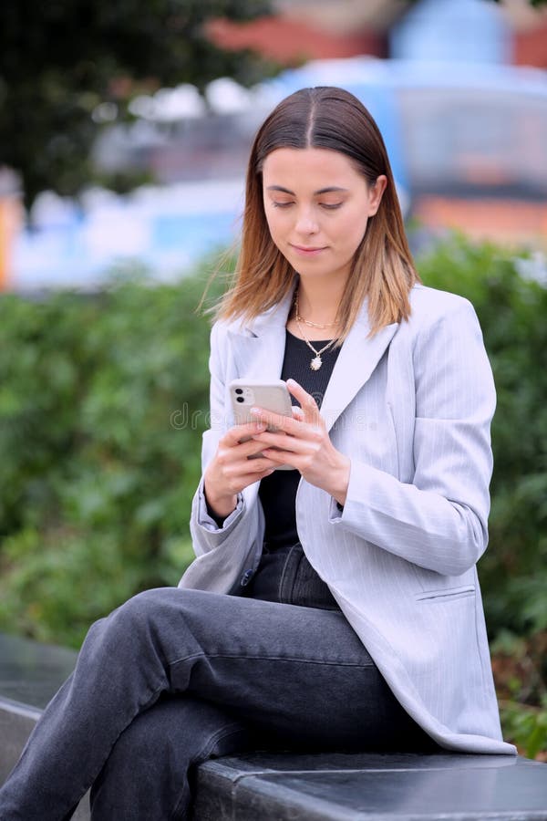Female Office Worker Outdoors Using Mobile Phone during Break Stock ...
