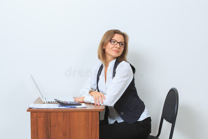 Female Office Worker Sits at Her Desk and Look Stock Image - Image of ...