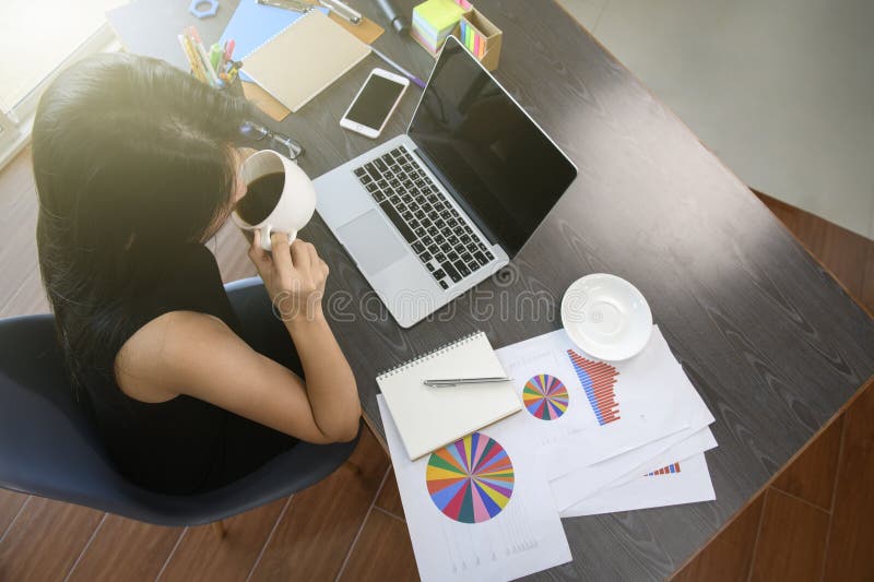 Female Office Worker Take a Coffee Break while Working with Laptop in ...