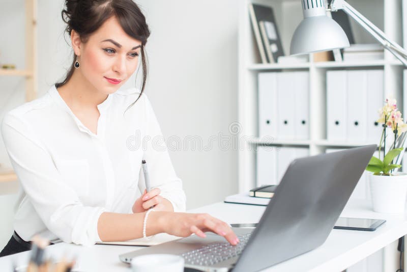 Female Office Worker Using Laptop at Her Workplace, Browsing ...