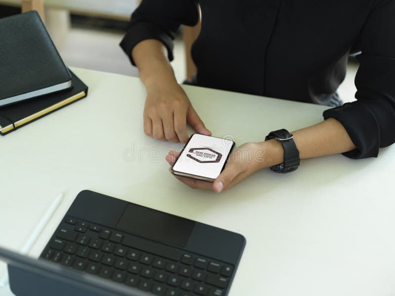 Female Office Worker Using Mock Up Smartphone on Work Table Stock Photo ...
