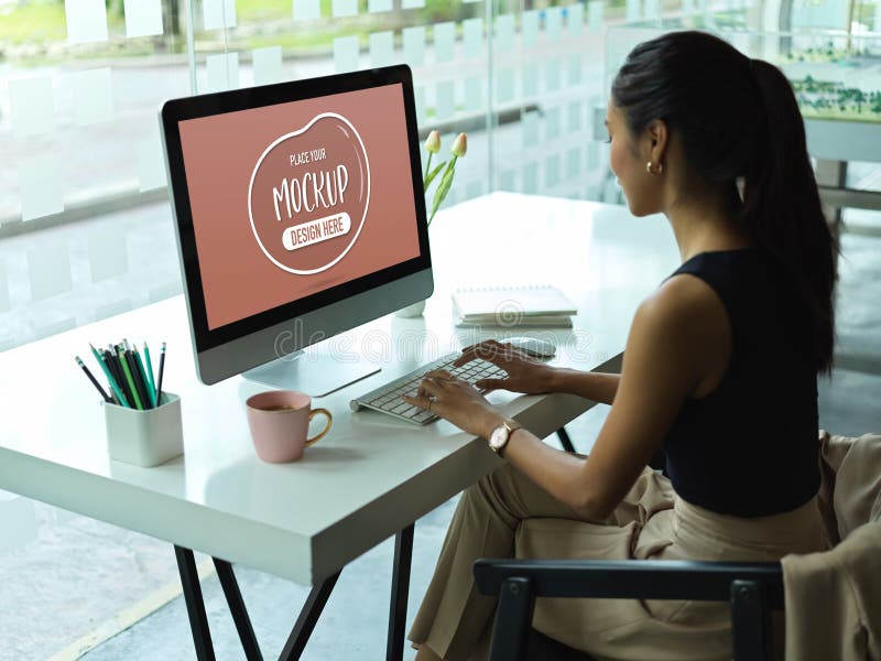 Female Office Worker Working on Mock Up Computer on Desk Stock Photo ...