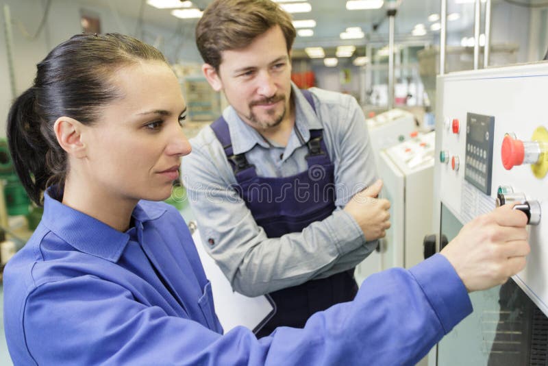 Female Operative Turning Switch on Machinery Controls Stock Photo ...