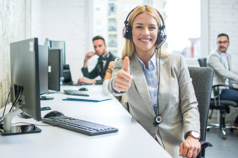 Female Operator with Headset Gesturing Thumb Up in Office. Stock Photo ...