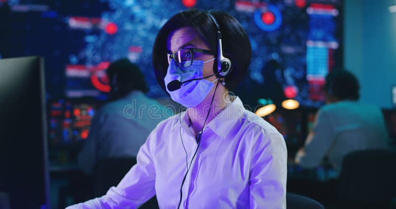 Female Operator in Mask Working in High Tech Security Center Stock ...