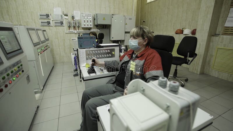 Control Room Operator Working in an Industrial Setting with ...
