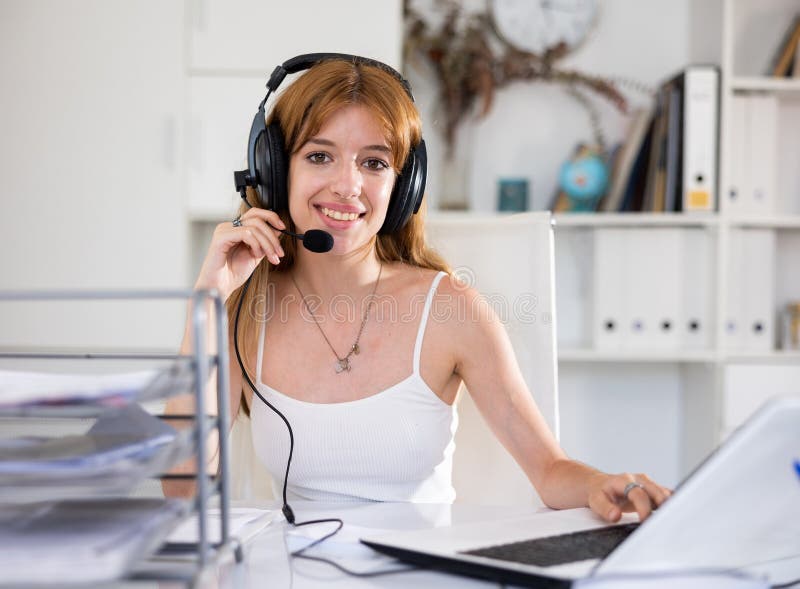 Female Operator Talking with Customer Using Headset at Company Office ...