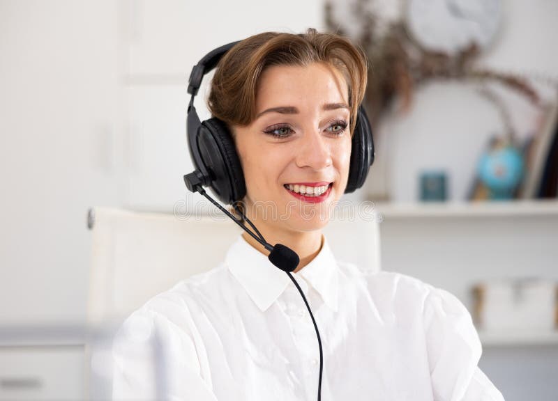 Female Operator Talking with Customer Using Headset at Company Office ...