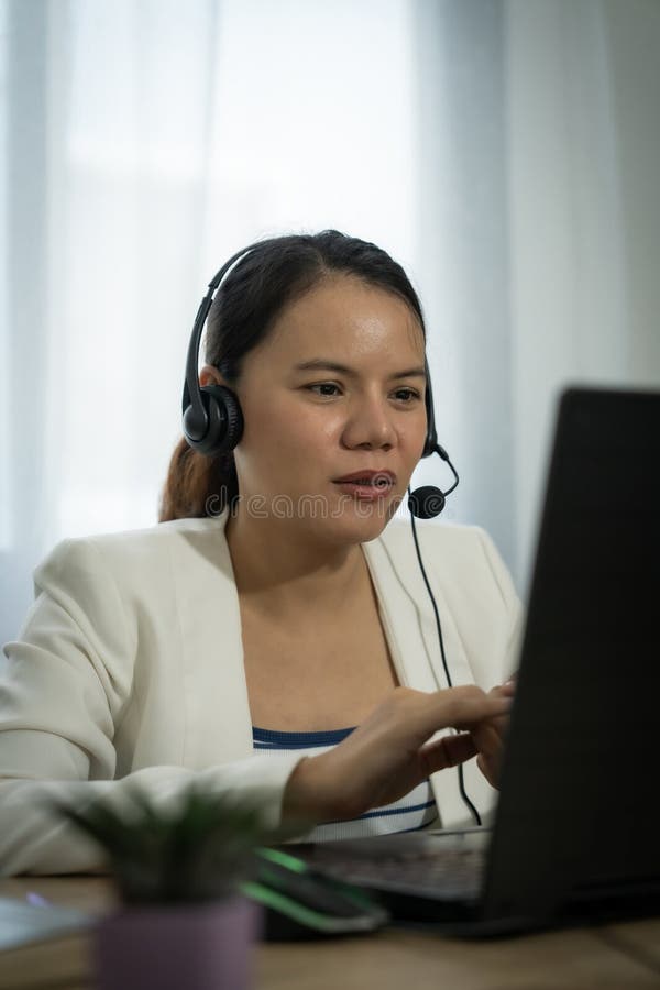 Female Operator Wearing a White Jacket and Blue Shirt is Smiling while ...
