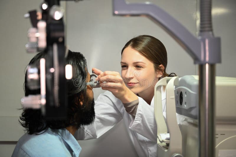 Female Ophthalmologist Checking Eye Vision of Male Patient with Special ... Female Ophthalmologist Checking Eye Vision of Male Patient with Special ...