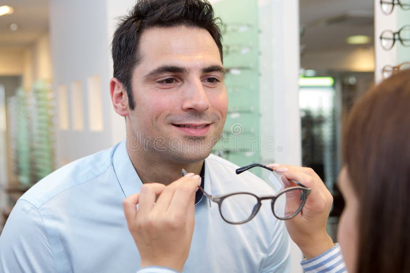 Female Optician Fitting Glasses in Male Customer Stock Image - Image of ...