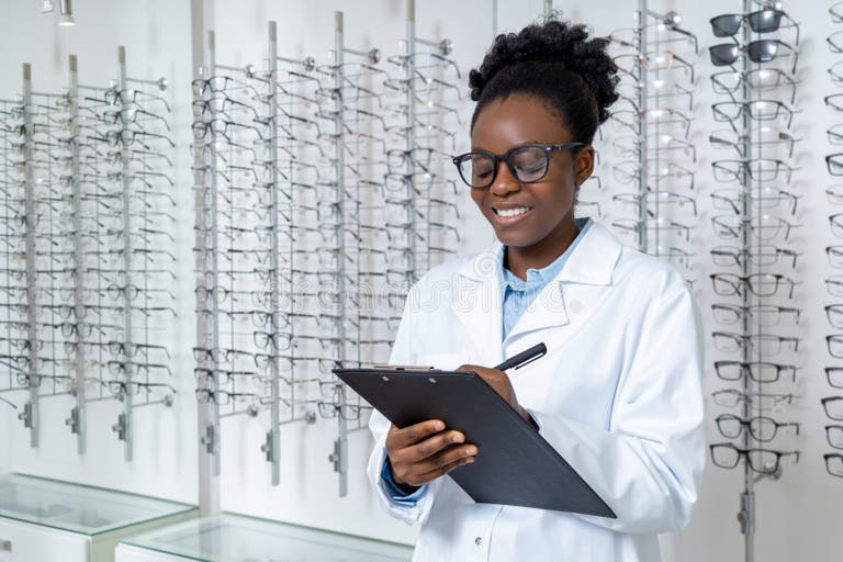 Female Optician in Lab Coat Making Notes and Smiling Stock Image ...