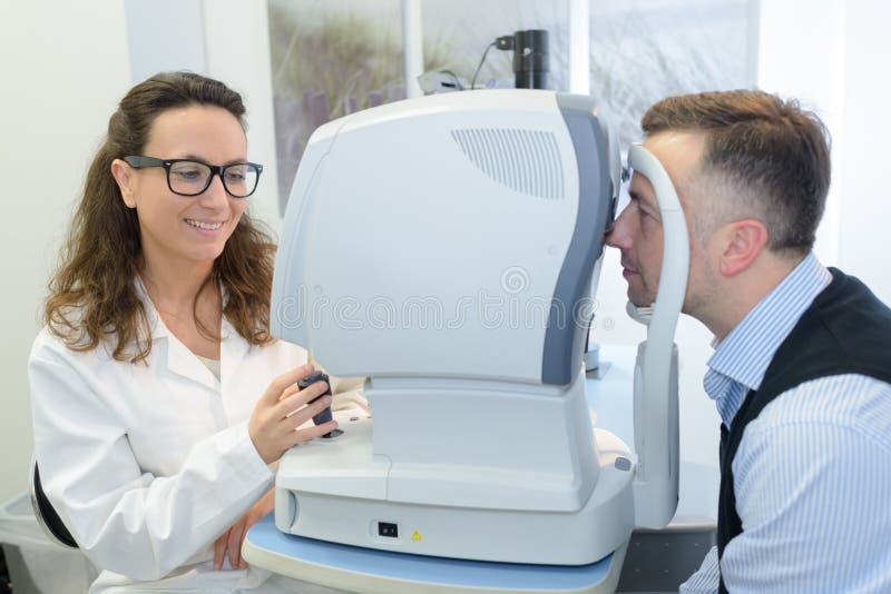 Female Optometrist Examining Male Patient on Phoropter Stock Image ... Female Optometrist Examining Male Patient on Phoropter Stock Image ...