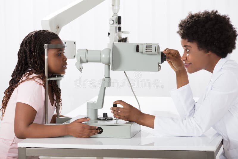 Female Optometrist Examining Patient Stock Image - Image of examination ... Female Optometrist Examining Patient Stock Image - Image of examination ...
