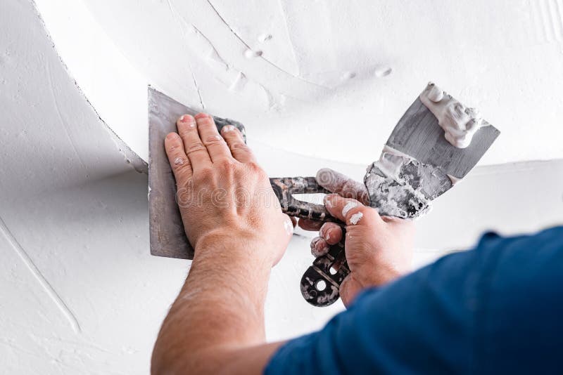 Female Painter Applying Putty To Ceiling. Stock Photo - Image of ...