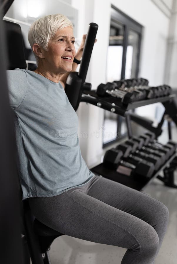 Active Senior Female Engaging in Strength Training at Gym Stock Photo ...