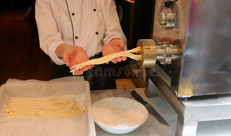 Female Pasta Maker during the Process of Extruding Fresh Egg Pasta and ...