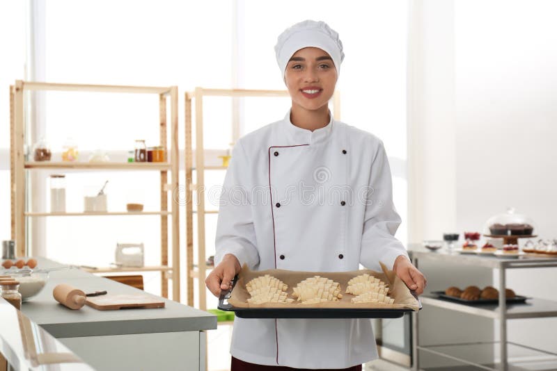 Female Pastry Chef Decorating Desserts with Berries at Table Stock ...