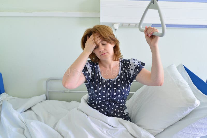 Female Patient with Headache on Bed in Hospital Ward Stock Photo ...