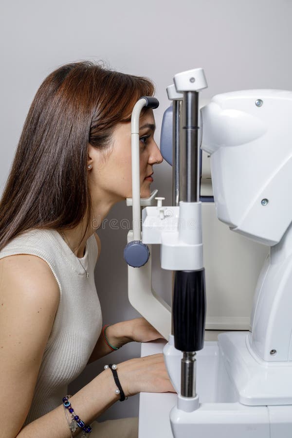 Female Patient Undergoing an Eye Examination Using a Specialized ...
