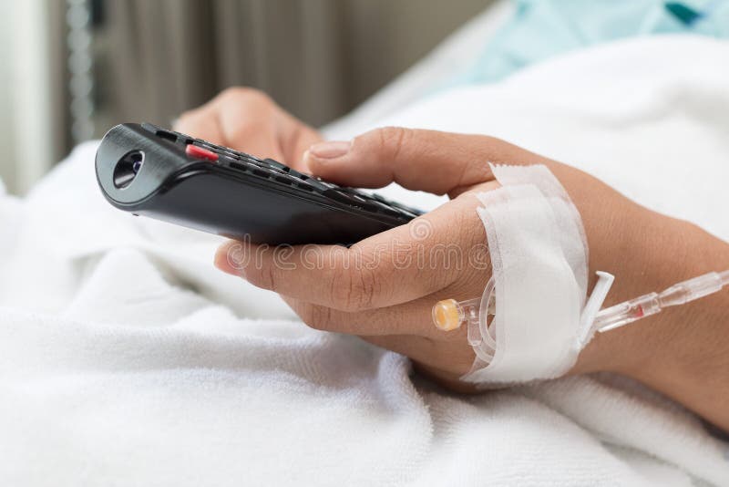 Female Patient Watching TV and Remote Control in Hand Stock Photo ...