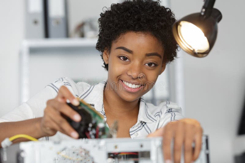 Female Pc Technician Fixing Pc Stock Photo - Image of studio, seated ...