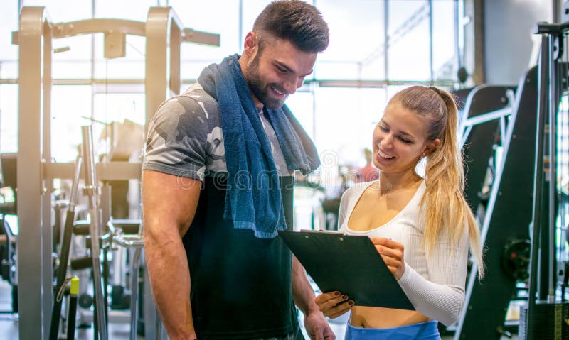 Female Personal Trainer Talking about Exercise Progress with Male ...