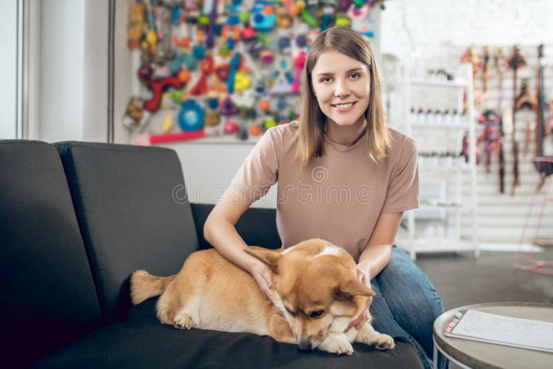 Female Pet Owner Sitting on a Sofa with Her Dog Stock Image - Image of ...