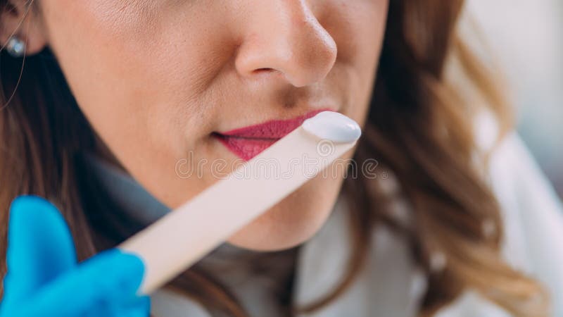 Female Pharmacist Testing Cream Scent in Laboratory Stock Photo - Image ...