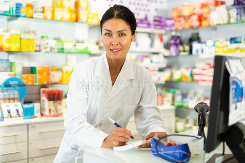 Female Pharmacist Working in Pharmacy, Using Computer Screen Stock ...