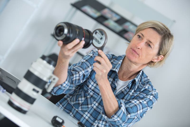 Female Photographer Adjusting Camera Stock Image - Image of assembling ...