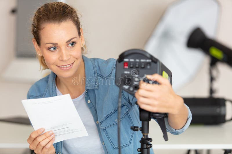 Female Photographer Adjusting Lighting Equipment Stock Photo - Image of ...