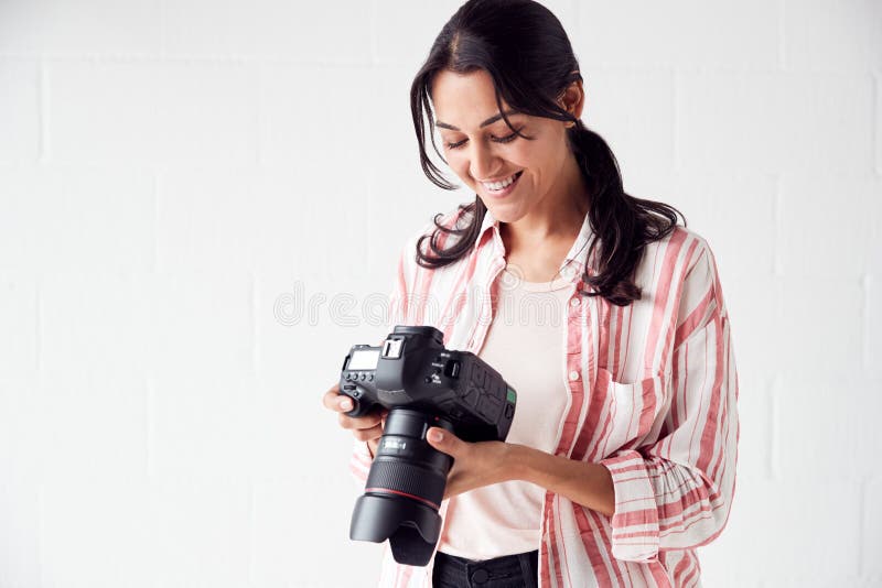 Female Photographer with Camera on Photo Shoot Against White Studio ...